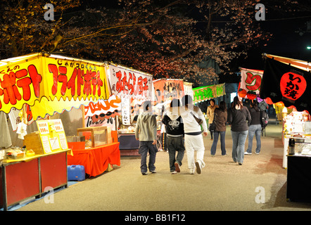 Food stalls with Japanese food at night, cherry blossom in spring ...