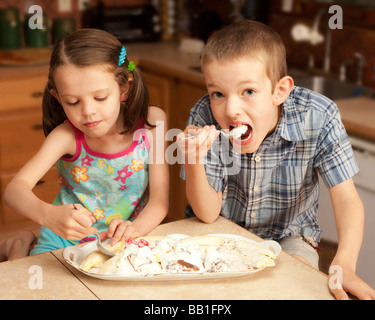Children eat ice-cream on their strollers on a sweltering day, in ...