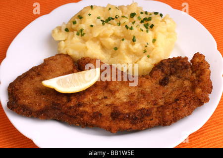 Wiener Schnitzel with potato salad topped with chopped chives Stock ...