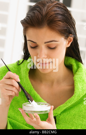 Young latin woman mixing color on palette at art studio Stock Photo - Alamy