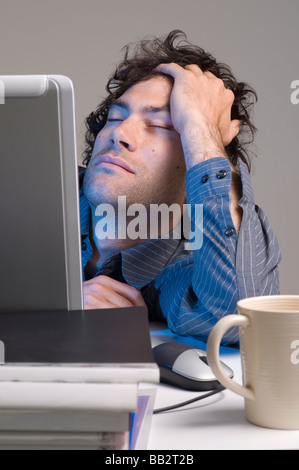 tired man at computer desk with coffe mug Stock Photo - Alamy