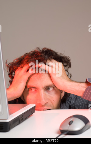 worried young businessman pulling the hair, isolated on white ...