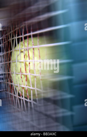 Tennis racket strings striking a tennis ball Stock Photo - Alamy