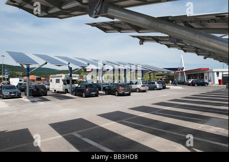 Solar panels used to simultaneously shade parked cars and to generate ...