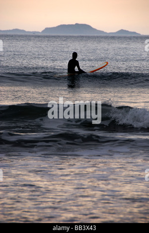 Lonely Surfer waiting for waves in the shore of a beach in Cantabria ...