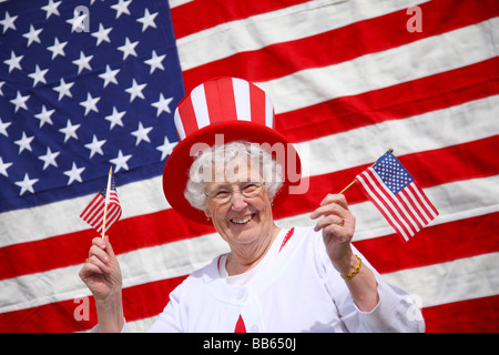 Smiling elderly woman waving flag of Austria in studio Stock Photo - Alamy