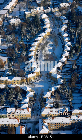 Aerial view of buildings, houses and snowy mountains peaks against a ...