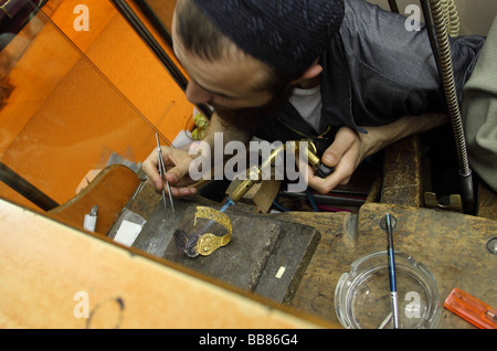 Goldsmith working on jewelery in workshop Stock Photo - Alamy
