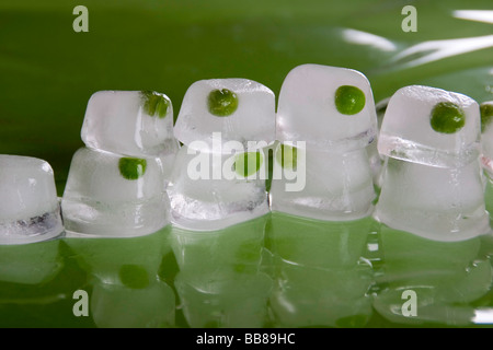 Frozen green peas with ice cubes, top view Stock Photo - Alamy