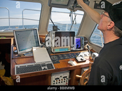 Steersman on command bridge with navigational instruments Kattegat Sea ...