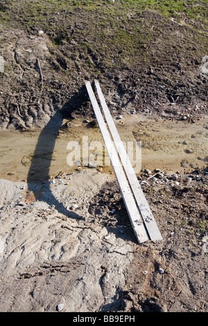 two planks crossing over a ditch Stock Photo - Alamy