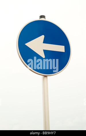 Round blue sign with arrow isolated against white sky Stock Photo - Alamy
