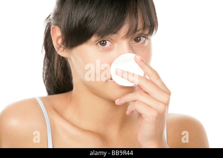 Woman removing makeup with cotton swab pad. Young girl taking care of ...