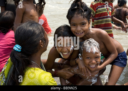 Indian mother bathing washing her kids with bucket in public hot Stock ...