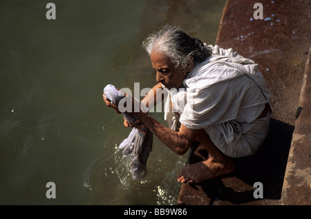 Hindu elder bathing in the sacred Ganges River Hinduism Varanasi Uttar ...
