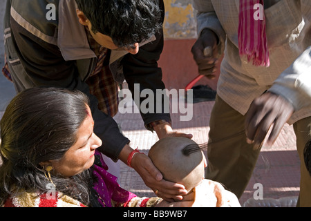 Mundan ritual head-shave for a boy of poor parents in a village temple ...