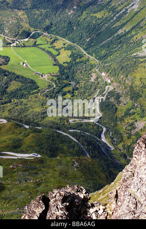 A birds eye view shot of a serpentine road leading through mountain ...