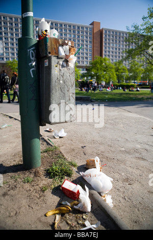 Germany Berlin overflowing rubbish bin and littered lawn in the ...