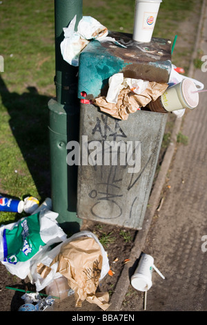 Germany Berlin overflowing rubbish bin and littered lawn in the ...