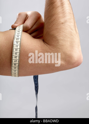 Measuring His Bicep Stock Photo - Alamy