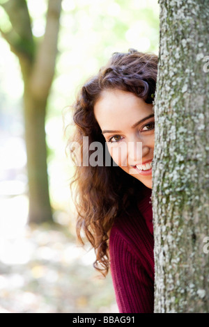 The vertical view of the female hiding behind a black umbrella while ...