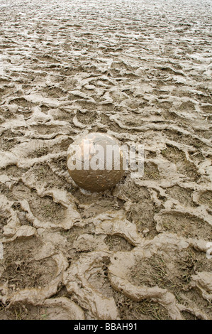 Dirty soccer ball in muddy puddle, space for text Stock Photo - Alamy