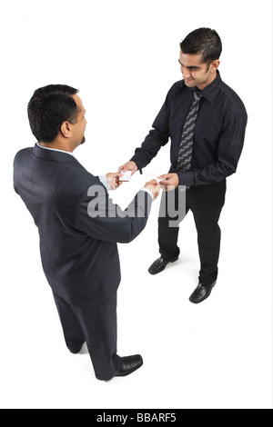Two businessmen standing and exchanging namecards Stock Photo - Alamy