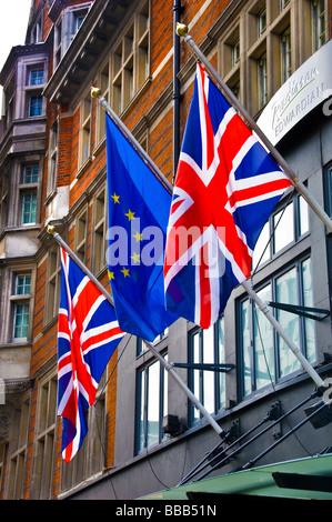 British Union Jack flags flying in the summer sky behind a flowering ...