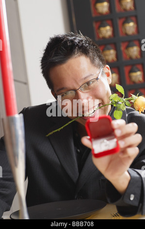 Man with rose stalk between his teeth Stock Photo - Alamy