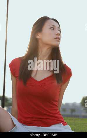 The vertical view of a woman arching back to the sun standing on the ...