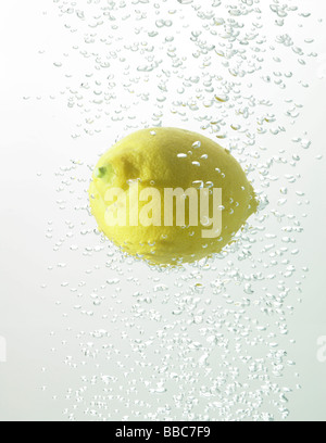 Fresh lemon in water with bubbles, isolated on white Stock Photo - Alamy