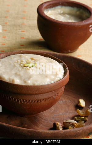 Indian sweet , mishti doi bengali mithai in earthen pot on white ...