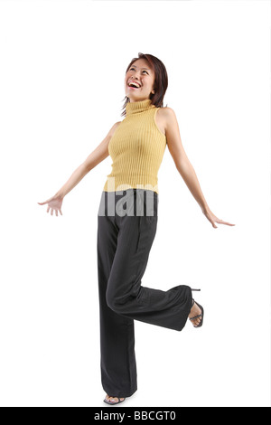 Black woman with one leg up sitting on a kitchen counter in a casual ...