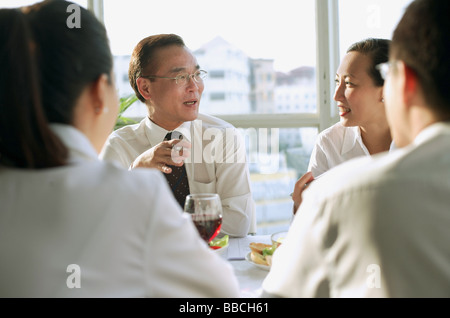 Executives discussing over lunch Stock Photo - Alamy