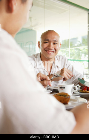 Over shoulder view of bald black man focused on thoughts touching ...