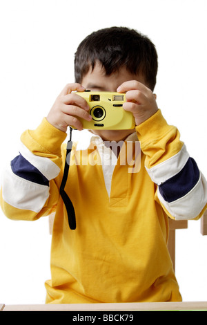 Boy standing and looking through camera Stock Photo - Alamy