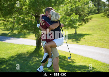 male and female golfer hug Stock Photo - Alamy