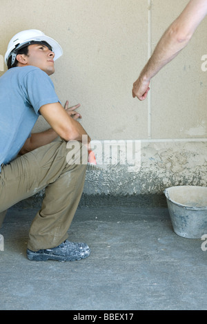 Mason receiving instructions from supervisor Stock Photo - Alamy