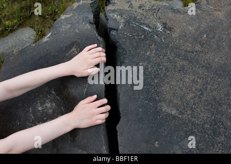A child's Hands "Breaking" open a rock Stock Photo - Alamy