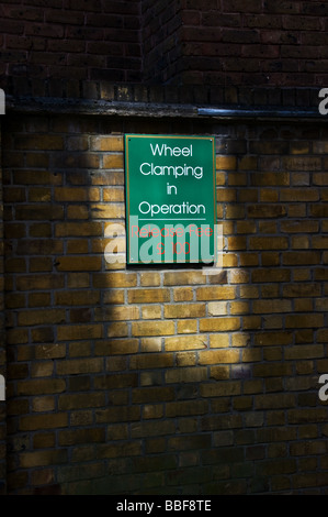 A wheel clamping warning sign on private land in Bingley, Yorkshire, UK ...