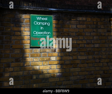 A wheel clamping warning sign on private land in Bingley, Yorkshire, UK ...