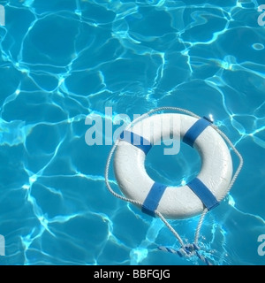 Lifeguard ring floating on blue water in swimming pool Stock Photo - Alamy