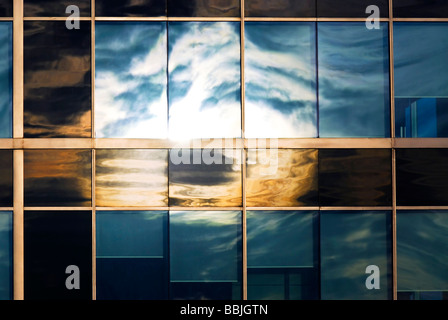 Reflection of a cloudy sky in glass wall of an office building Stock ...