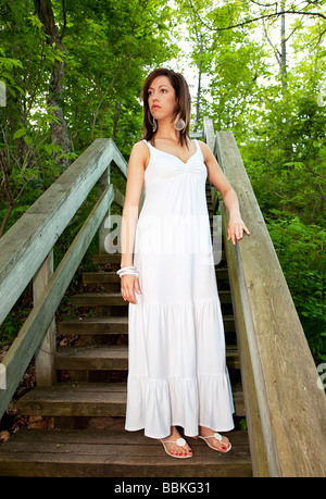 Beautiful woman standing on steps Stock Photo - Alamy