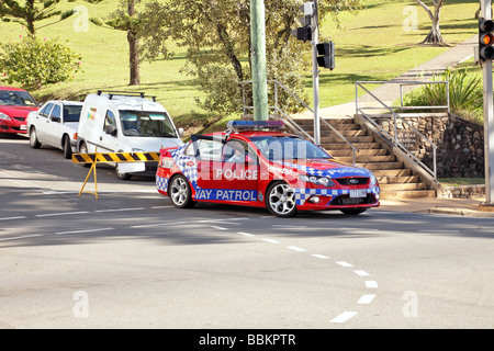 Police car providing a raod block for street parade Stock Photo - Alamy
