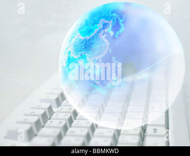 Digital composite of globe on keyboard Stock Photo - Alamy