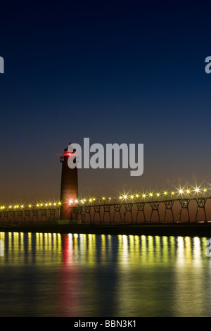 The lighthouse pier at Grand Haven, Michigan, shown in silhouette as ...
