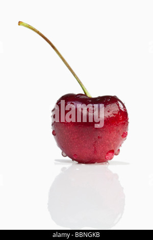 Single ripe cherry without stem isolated on white background with ...