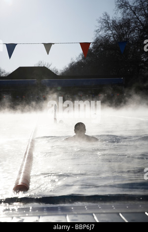 People swim in an outdoor swimming pool in London, Tuesday, June 23 ...