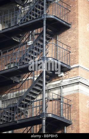 The fire escape stairs on the side of a tall apartment building in ...